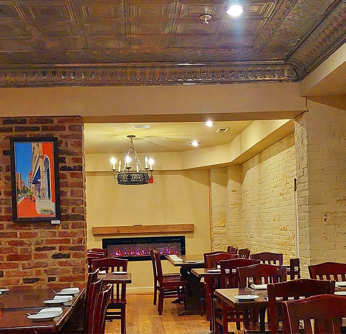 Exposed brick walls meet ornate tin ceilings in this dining room that whispers, "Stay awhile, the food is worth it."