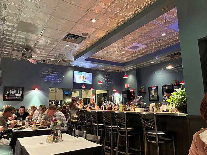 Teal walls adorned with philosophical quotes and a pressed tin ceiling create an atmosphere where both mind and stomach leave satisfied.