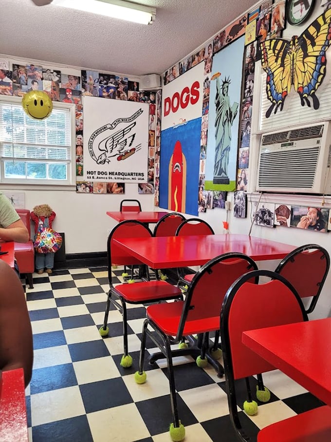 The interior's checkerboard floor and memorabilia-packed walls create the perfect shrine to hot dog culture, complete with tennis balls on chair legs.