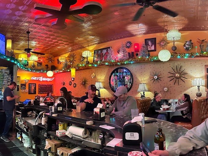 Mid-century meets psychedelic in this retro wonderland where sunburst clocks and twinkling lights create the perfect backdrop for serious sandwich consumption.