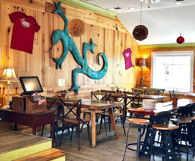 Inside, wooden warmth meets reptilian charm with that stunning turquoise lizard sculpture commanding the room like the host of this culinary party.