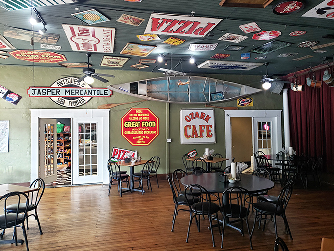 Step inside to a time capsule of Americana—vintage signs blanket the ceiling, wooden floors worn smooth by decades of hungry patrons seeking comfort food paradise.