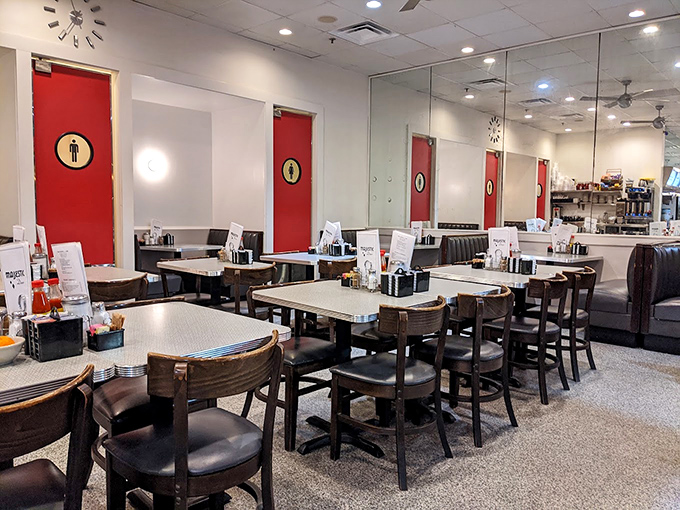 Classic diner geometry: clean lines, comfortable booths, and those red bathroom doors that pop against white walls. The stage is set for breakfast magic.