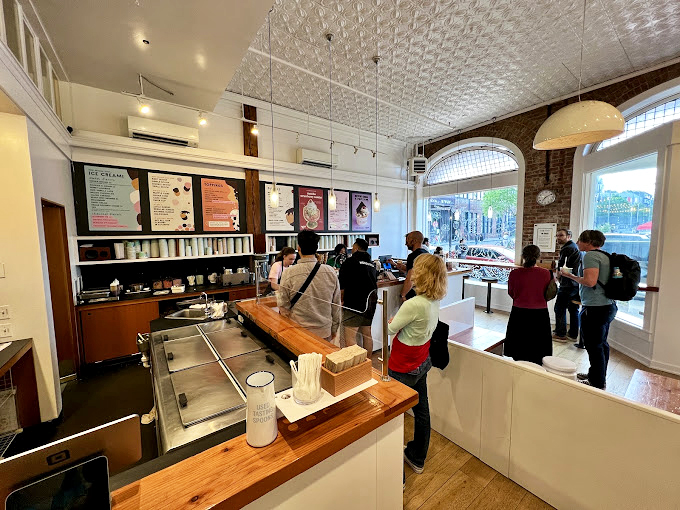 Ice cream democracy in action &ndash; patrons ponder life's most important decision while the minimalist interior keeps the focus where it belongs: on your next scoop.