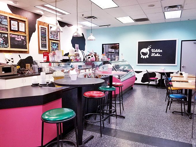 The retro-chic interior combines playful cow motifs with bright turquoise walls, creating a space where nostalgia and modern comfort mingle deliciously.