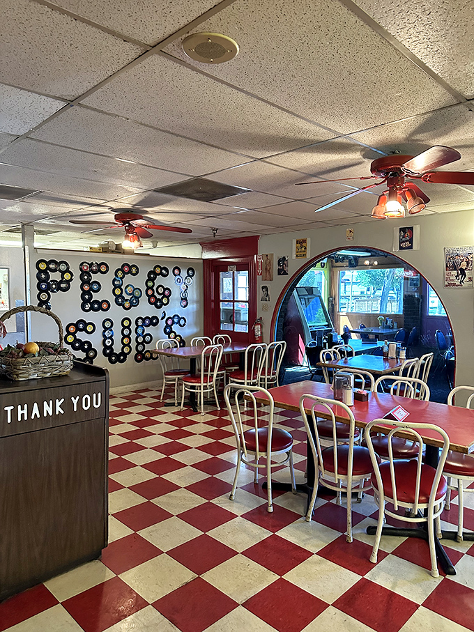 Vinyl records spelling "PEGGY SUE" against classic red and white checkerboard floors&mdash;this place doesn't just serve nostalgia, it IS nostalgia.