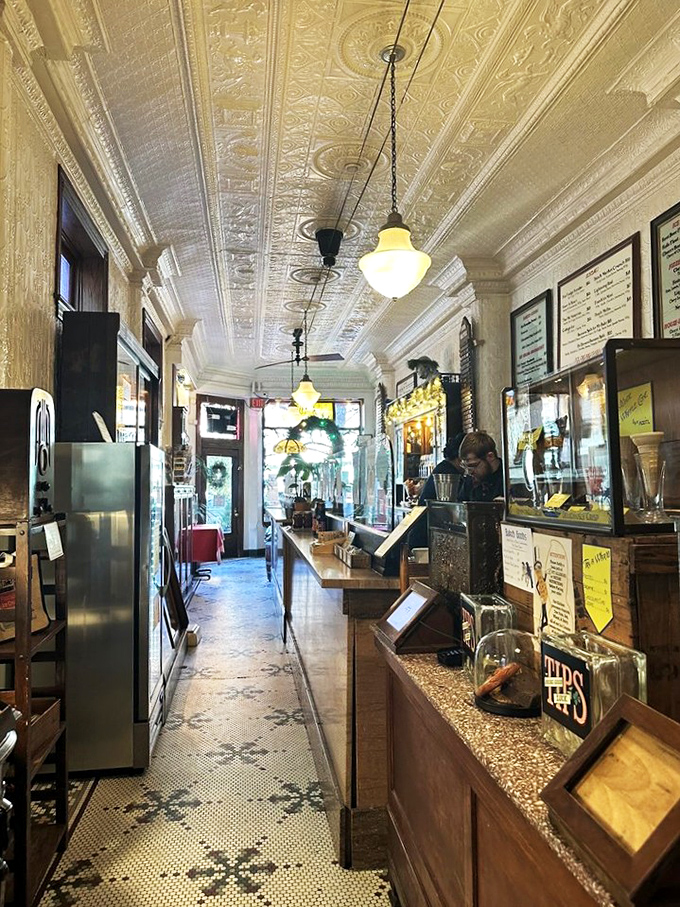 Step inside and time travel to the early 1900s, where the narrow space, ornate tin ceiling, and pendant lights create an authentic soda fountain experience.