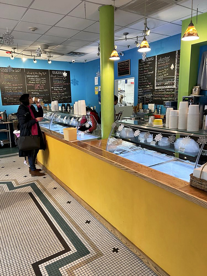 The sunny interior combines cheerful yellows and blues with classic caf&eacute; seating, creating the perfect backdrop for serious ice cream contemplation.