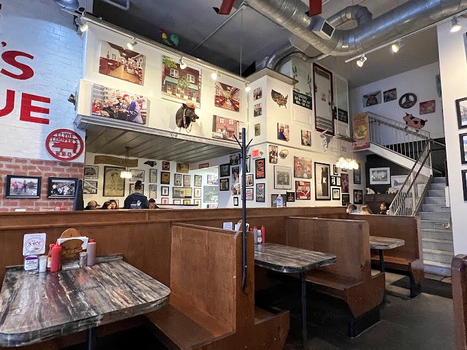 Step inside and you're surrounded by history &ndash; wooden booths worn smooth by decades of eager elbows and walls that tell the story of Raleigh's barbecue devotion.