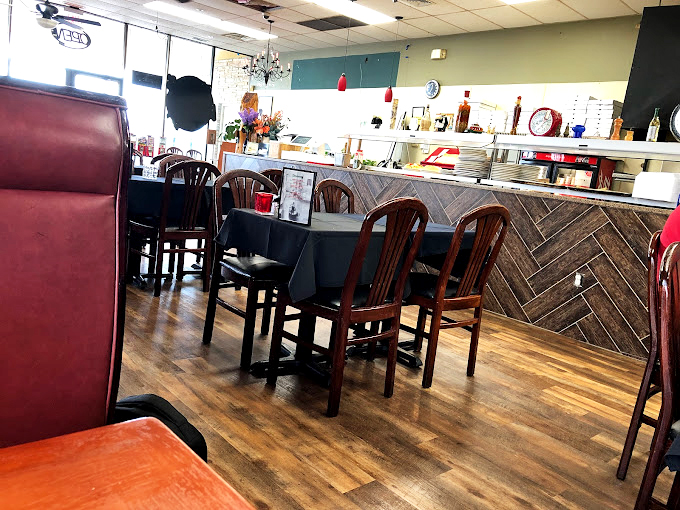 Classic wooden chairs, herringbone paneling, and no-nonsense tables create that rare atmosphere where comfort trumps pretension. This is eating, not "dining."