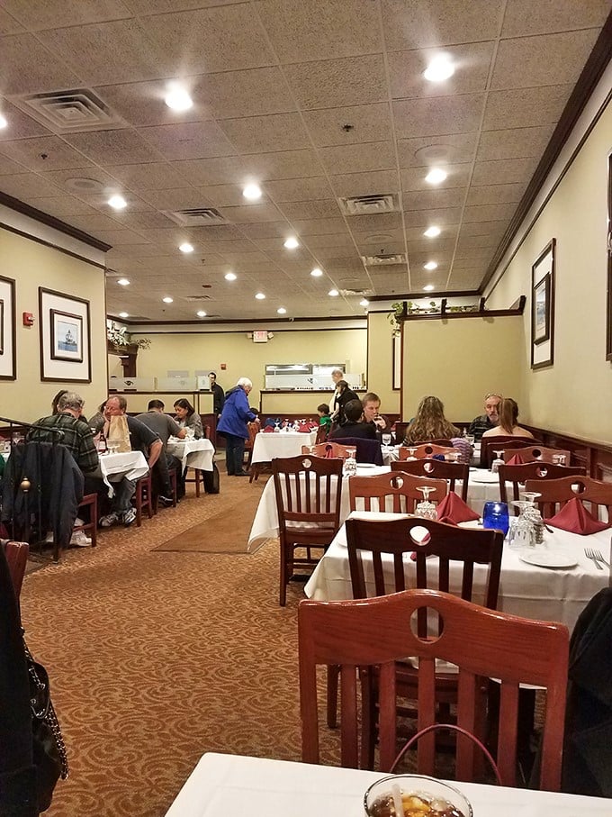Classic white tablecloths and warm wood tones create that perfect "come as you are, leave as family" atmosphere where seafood memories are made.
