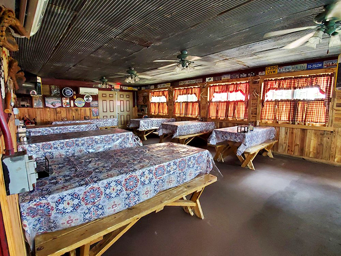 Picnic tables with floral tablecloths and wood-paneled walls create that "grandma's country kitchen meets smokehouse" vibe that promises authentic eats.