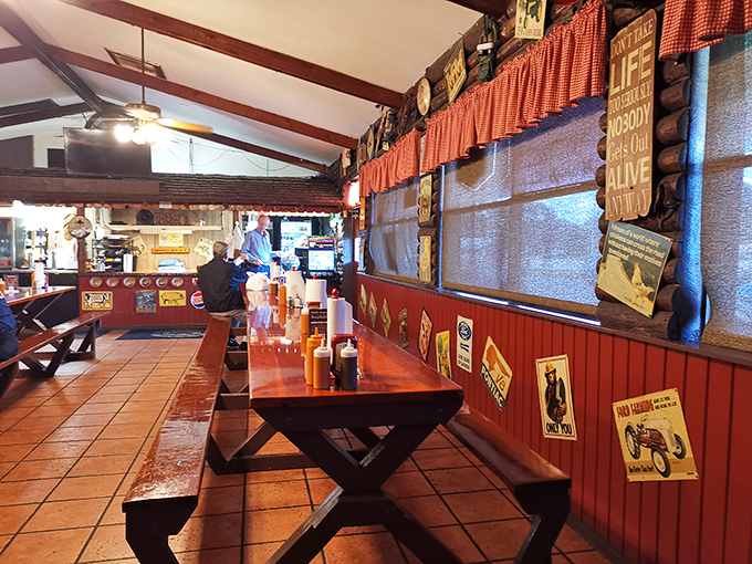 Inside, picnic tables and red-checkered curtains create that perfect "come as you are" atmosphere where napkins aren't just suggested&mdash;they're mandatory.