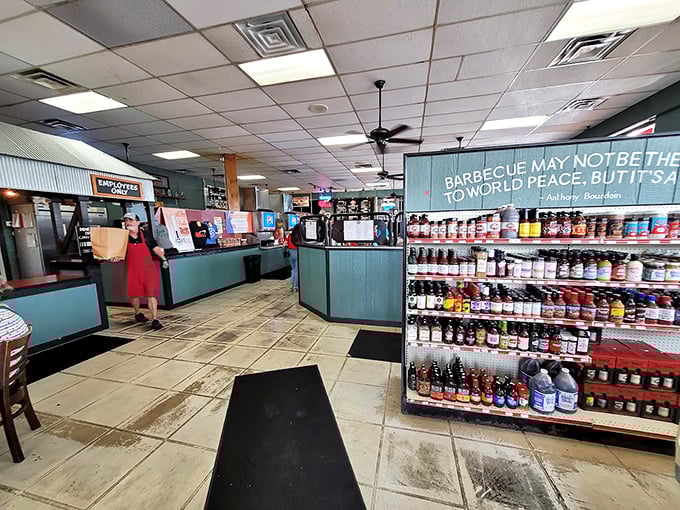Where sauce bottles line up like soldiers and the aroma of smoked meat is your welcoming committee. The barbecue philosophy on the wall says it all.