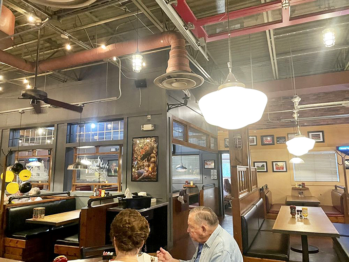 Industrial-chic meets cozy comfort inside FireSide Grille, where exposed ductwork and warm wood create the perfect backdrop for culinary adventures.