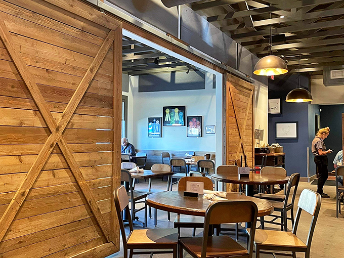 Rustic barn doors frame a dining space where barbecue dreams come true&mdash;warm wood tones and industrial touches creating the perfect smoke-infused sanctuary.