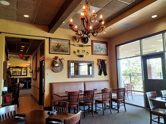 Western charm meets steakhouse elegance inside, where cowboy artifacts and warm lighting create the perfect backdrop for serious meat appreciation.