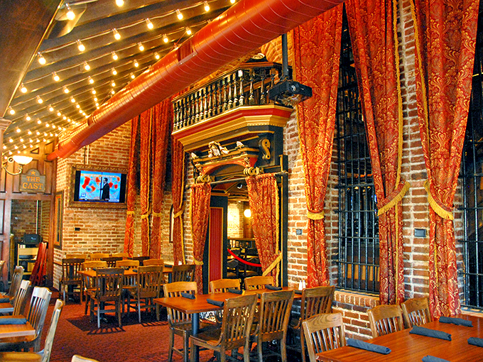 Theatrical red curtains frame the dining space like you've stumbled into a delicious Broadway production where the food gets all the standing ovations.