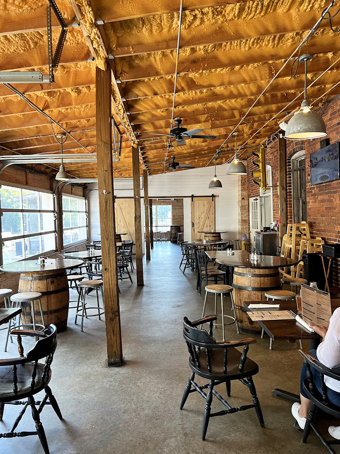 Step inside to discover rustic-industrial perfection—wooden beams, exposed brick, and barrel tables create an atmosphere that's equal parts brewery charm and Southern comfort.