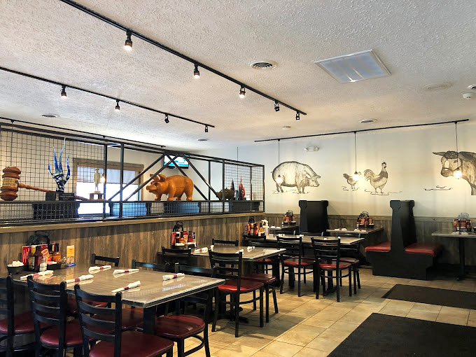 Farm animals on the wall keep watch over diners like barbecue guardian angels. That pig statue isn't decoration&mdash;it's inspiration.