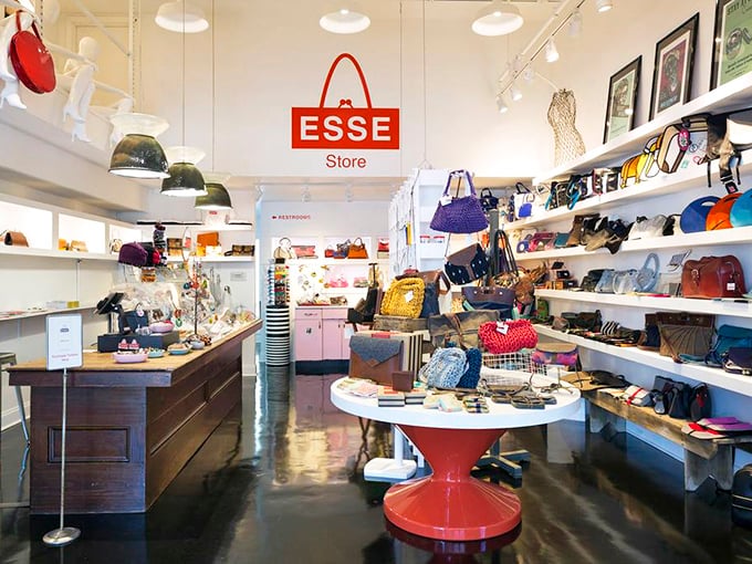 Inside the ESSE Store, a vibrant red display table anchors a space where handbags aren't just accessories, but objects of desire.