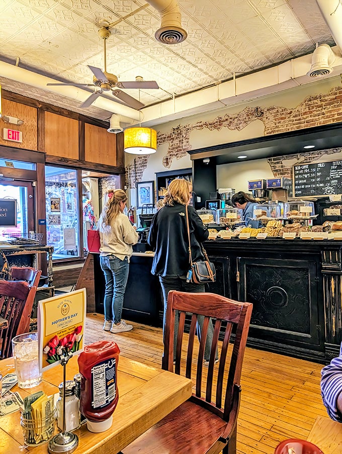Inside, exposed brick walls and vintage tin ceiling tiles create the perfect backdrop for breakfast magic. Comfort begins before the first bite.
