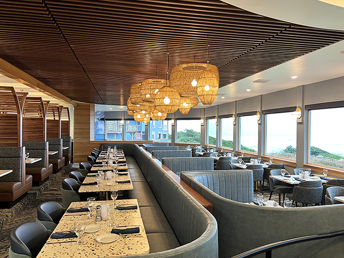 Blue banquettes and wicker pendant lights create an atmosphere so perfectly "beachy elegant" that even your seafood feels underdressed.