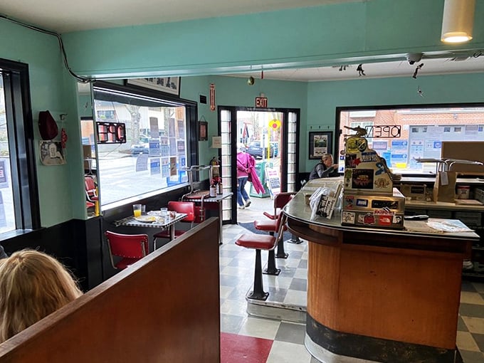 Classic diner charm awaits inside with mint green walls, checkerboard floors, and those red counter stools that have supported breakfast enthusiasts for generations.