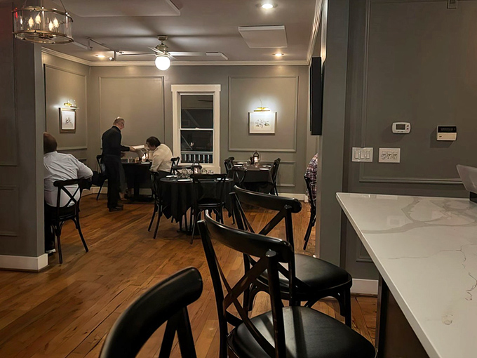 Elegant simplicity at its finest. Gray walls, wooden floors, and tasteful artwork create the perfect backdrop for the real star&mdash;what's about to arrive on your plate.