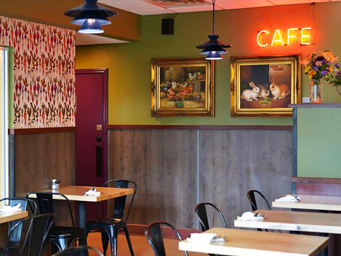 Vintage rabbit paintings and a glowing neon sign create that rare atmosphere where hipster meets homey—and both feel perfectly at home.