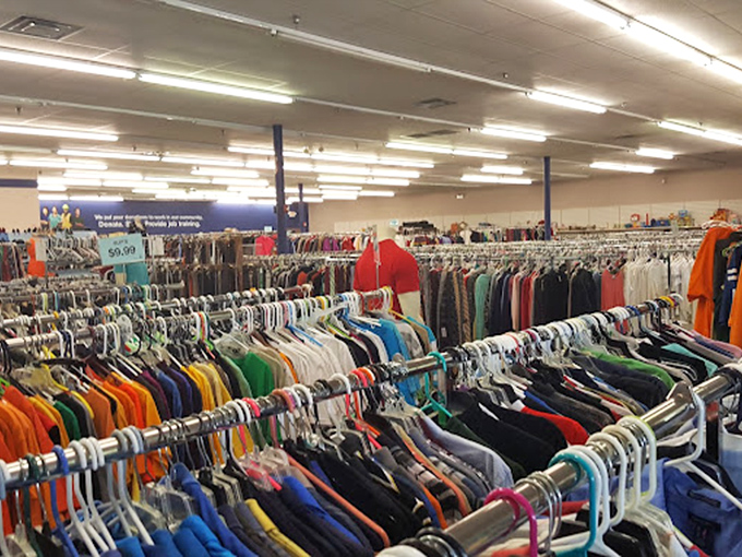 A sea of color-coded clothing stretches to the horizon, where one person's discarded button-down becomes another's job interview confidence booster.