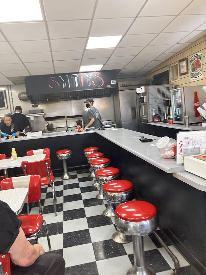 Classic Americana in full display: red vinyl stools, black and white checkered floors, and a counter where regulars have been solving the world's problems since Eisenhower was in office.