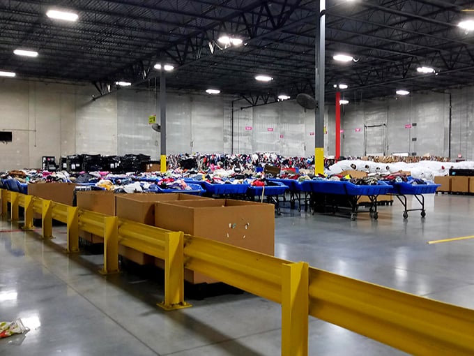 Industrial-chic meets thrift paradise in this cavernous warehouse where blue bins stretch toward the horizon like an ocean of potential finds.