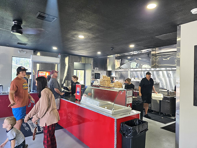 Where burger magic happens. The bright red counter and open kitchen let you witness the artistry behind Florida's most beloved patties.