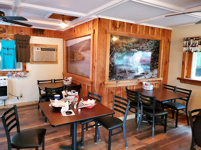Rustic wood paneling and nature photos create that "grandpa's cabin meets meat paradise" vibe that somehow makes everything taste better.