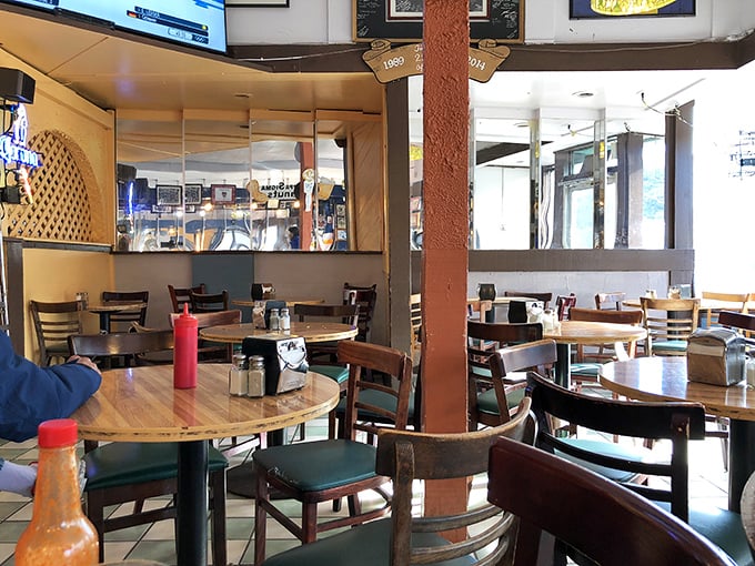 Inside, wooden tables and comfortable chairs create that perfect "everybody knows your name" vibe that chain restaurants spend millions trying to replicate.