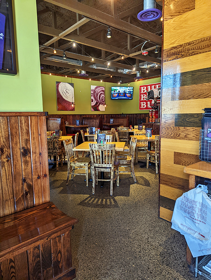 Inside, rustic wood meets vibrant green walls, creating that perfect sweet spot between "nice enough for date night" and "comfortable enough to wear jeans."
