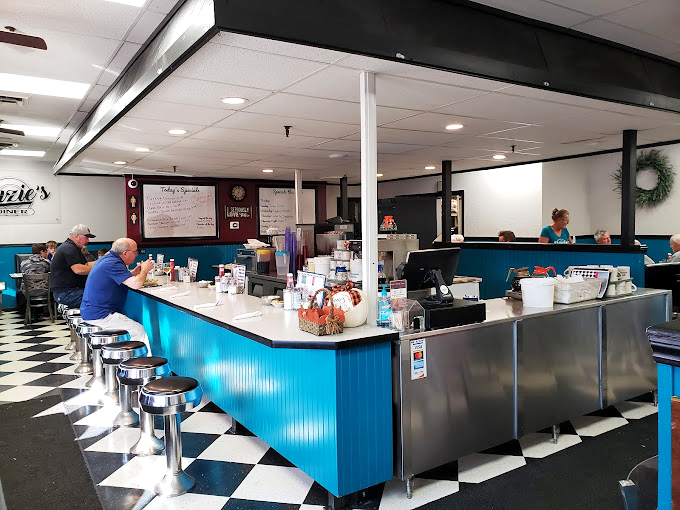 Classic diner magic happens at this blue counter where breakfast dreams come true and coffee cups never stay empty for long.
