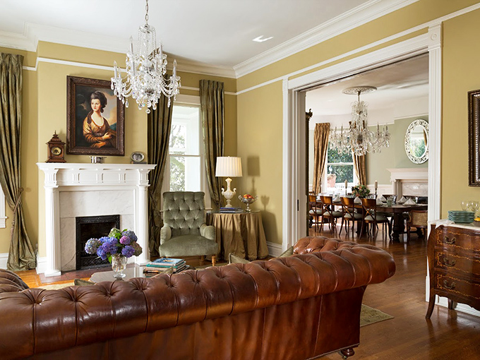 Elegance meets comfort in this living room where Scarlett O'Hara wouldn't dare throw a tantrum. That leather chesterfield sofa is practically begging you to sink in with a good book.