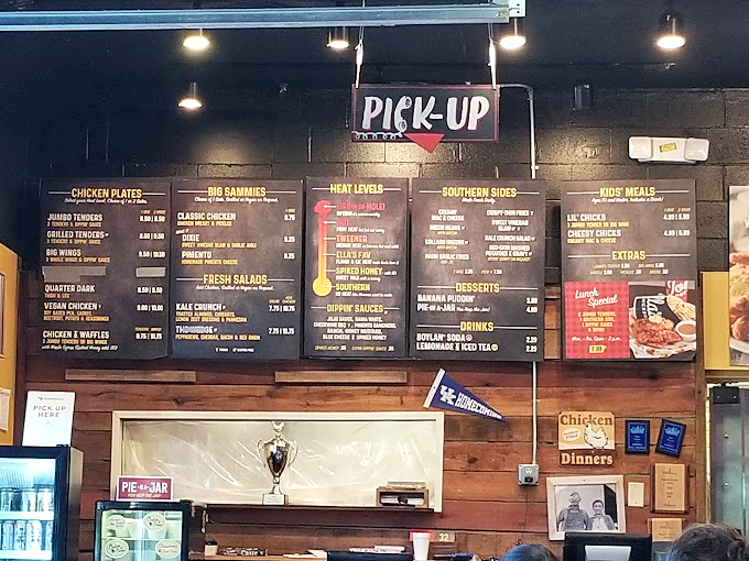 That menu board isn't just listing food&mdash;it's mapping out your journey from "Southern" (for spice novices) to "Fire-In-Da-Hole" (for those who laugh in the face of capsaicin).
