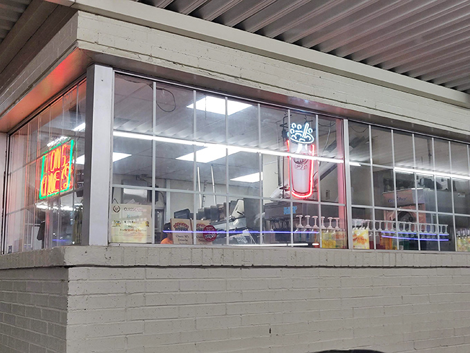 Behind this glass lies burger alchemy. The ordering window&mdash;where dreams are placed and delivered on paper-wrapped platters of nostalgic perfection.