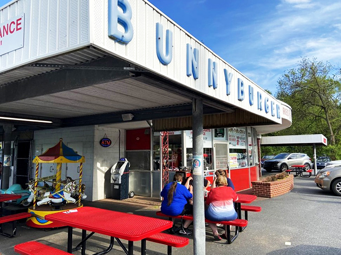 These classic red picnic tables have hosted generations of hungry families, where conversations flow as freely as the milkshakes and memories are made between bites. 