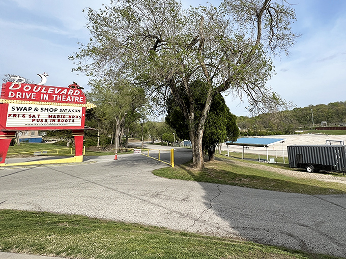 The iconic red marquee announces more than movies; it's a beacon of summer nights, promising entertainment under Kansas stars.