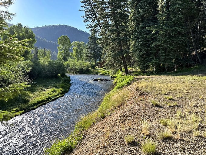 Nature's perfect postcard: sunlight dancing on rippling waters while mountains stand guard in the distance.