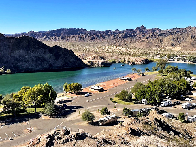 Buckskin Mountain's rust-colored peaks rise from turquoise waters like they're auditioning for National Geographic's cover shot.