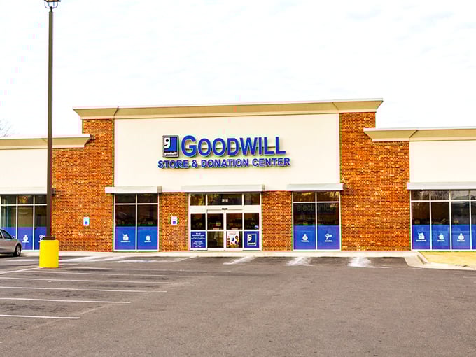 Goodwill's brick-and-glass facade houses more potential stories than a library. Each donation a chapter, each purchase a new beginning.