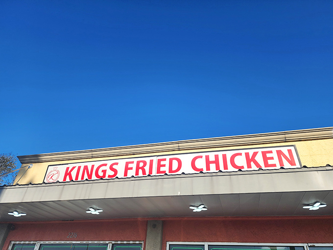 Kings Fried Chicken's bold red sign isn't just a landmark &ndash; it's a beacon of crispy, golden hope for hungry travelers.