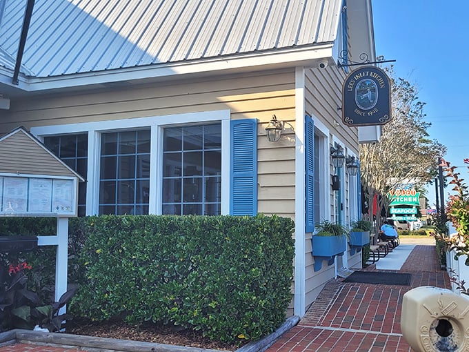 Lee's Inlet Kitchen's charming yellow cottage with blue shutters looks like it belongs in a coastal fairy tale.