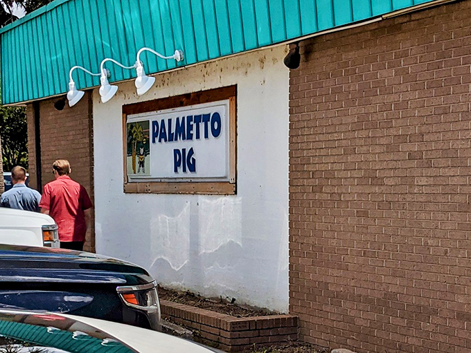 The Palmetto Pig sign beckons like an old friend. No fancy frills, just the promise of BBQ perfection.