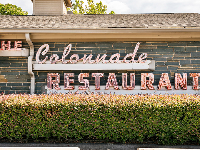The Colonnade's vintage sign glows with promise, like a beacon calling comfort food enthusiasts home since Eisenhower was president.